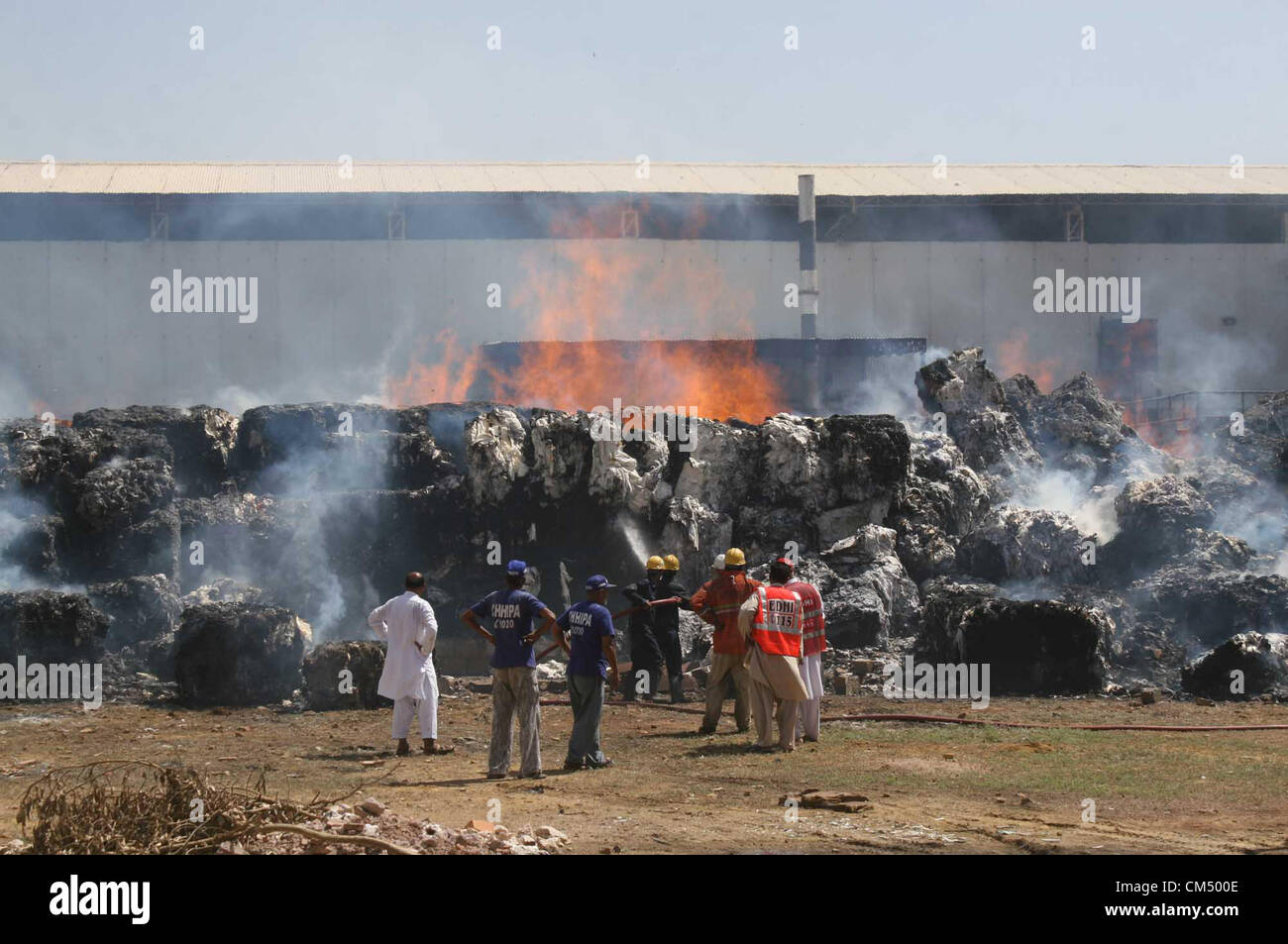 Fire fighters extinguish fire that broke out in cotton warehouse ...