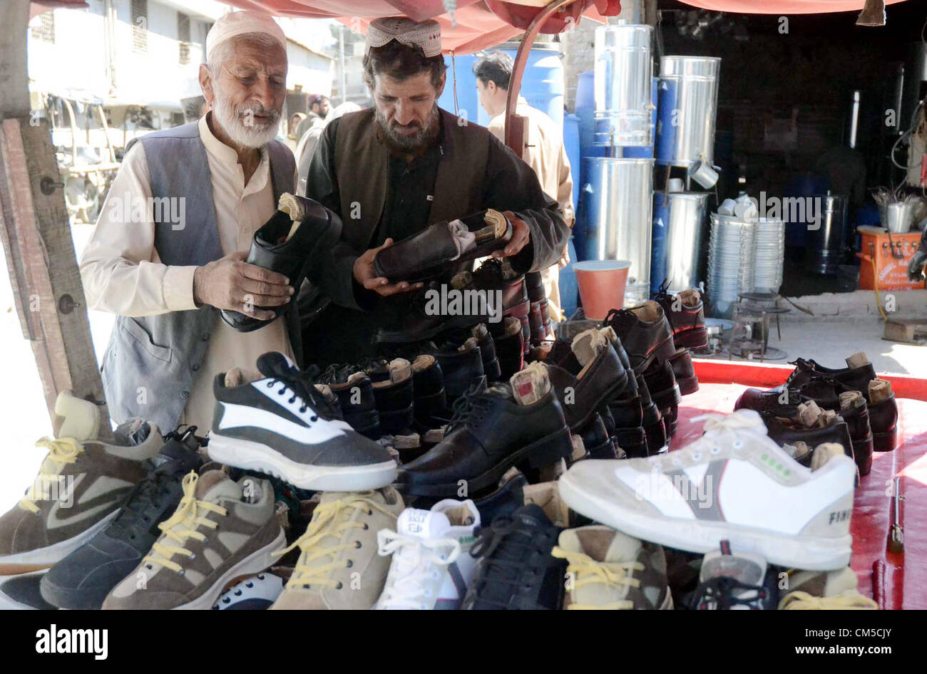A man sells used shoes to earn his livelihood for support his family ...
