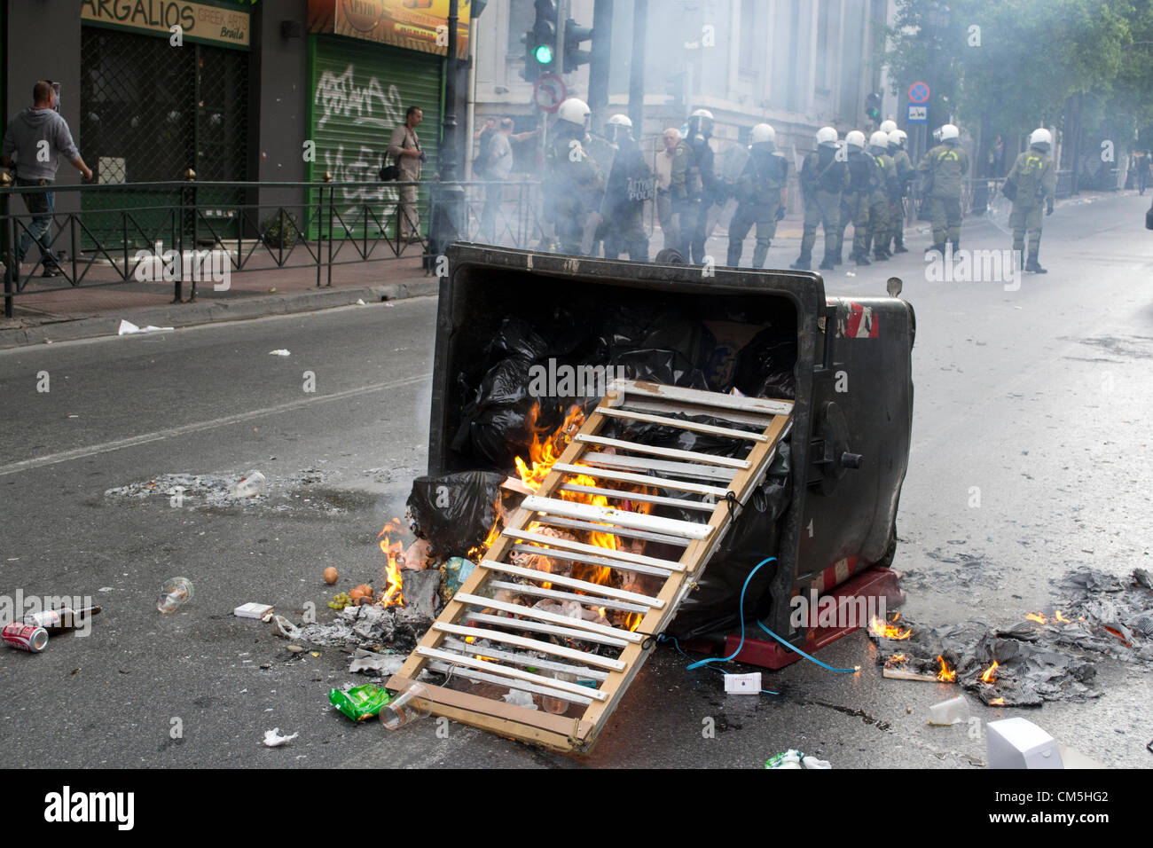 A garbage bin burns during riots in Athens Stock Photo - Alamy