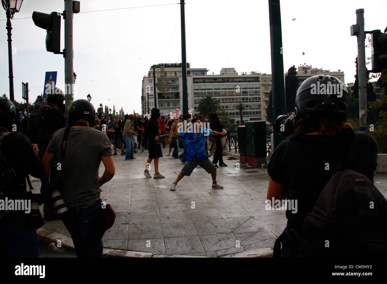 Athens, Greece. 9th October 2012. Protesters throw rocks at riot ...