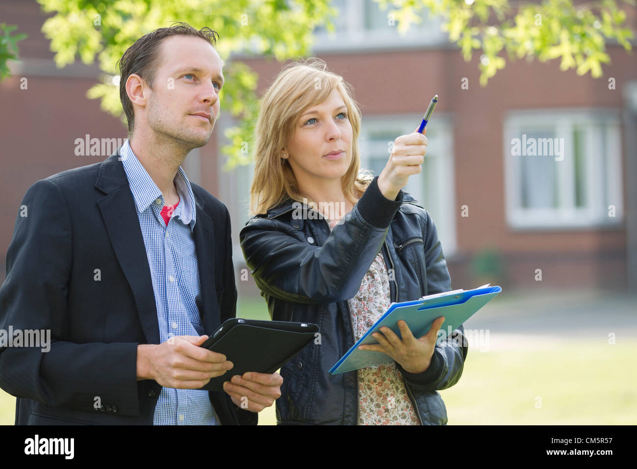 Busy people discussing new project or working plan outdoors Stock Photo ...