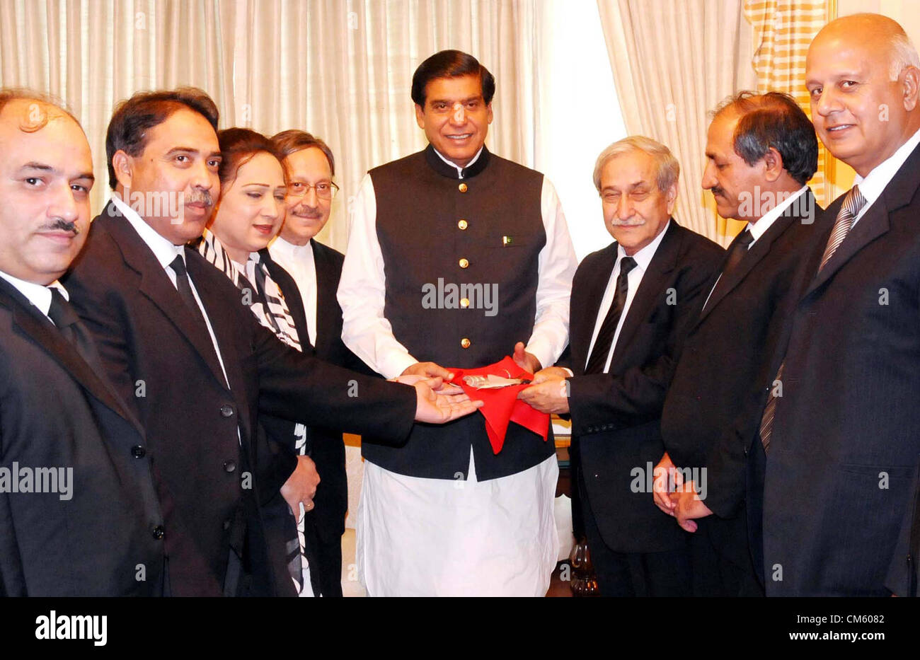 Prime Minister Raja Pervez Ashraf handing over keys of Toyota Hiace to ...
