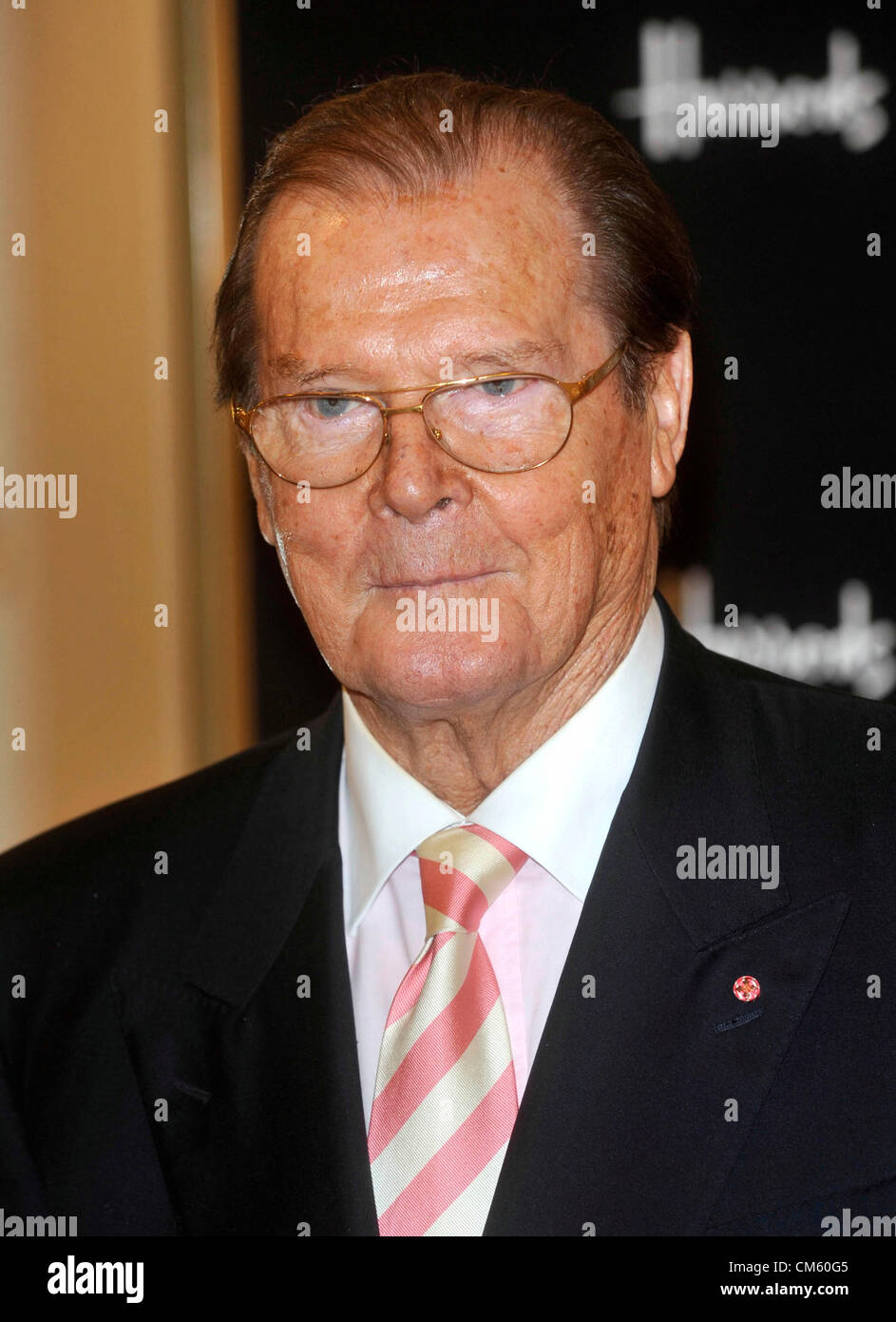Sir Roger Moore signing copies of his book 'Bond on Bond' at Harrods ...