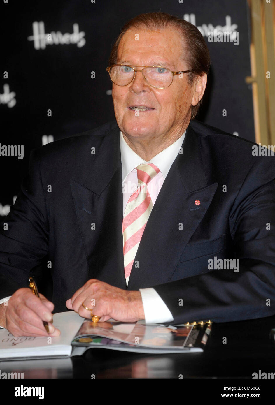 Sir Roger Moore signing copies of his book 'Bond on Bond' at Harrods ...