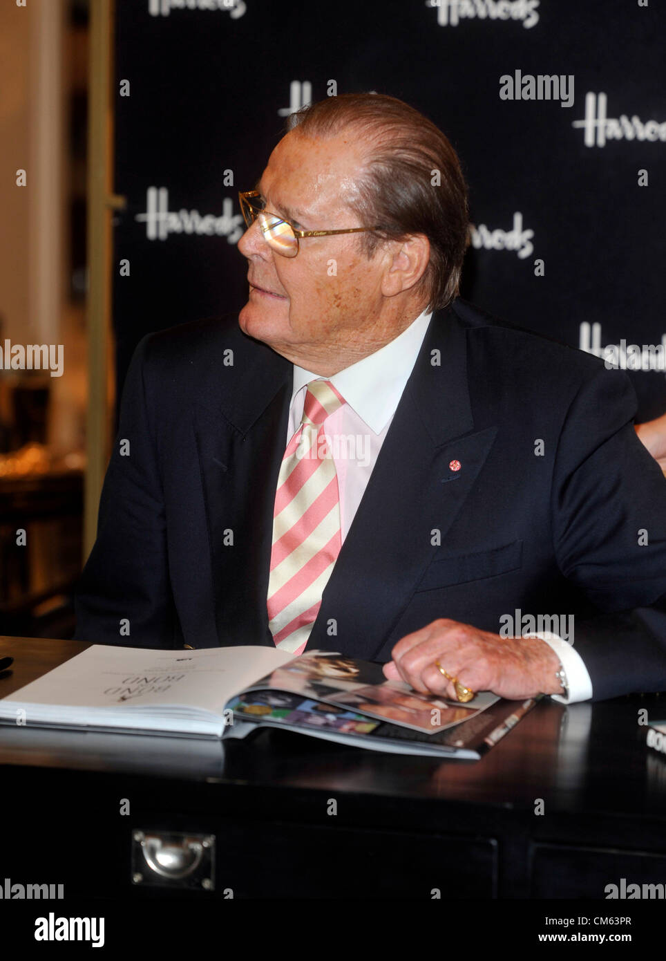 Sir Roger Moore signs copies of his new book 'Bond On Bond' at Harrods ...