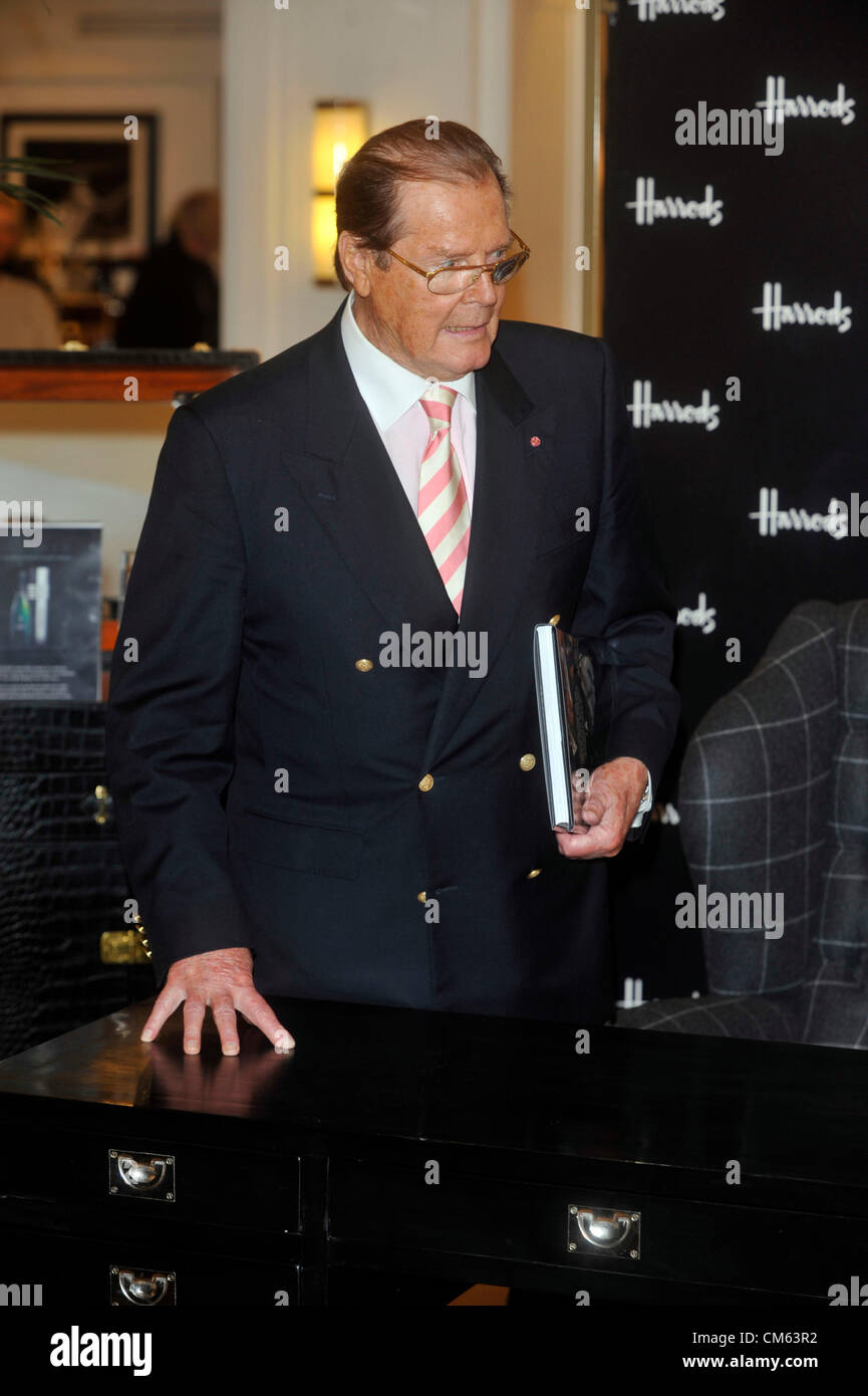 Sir Roger Moore signs copies of his new book 'Bond On Bond' at Harrods ...