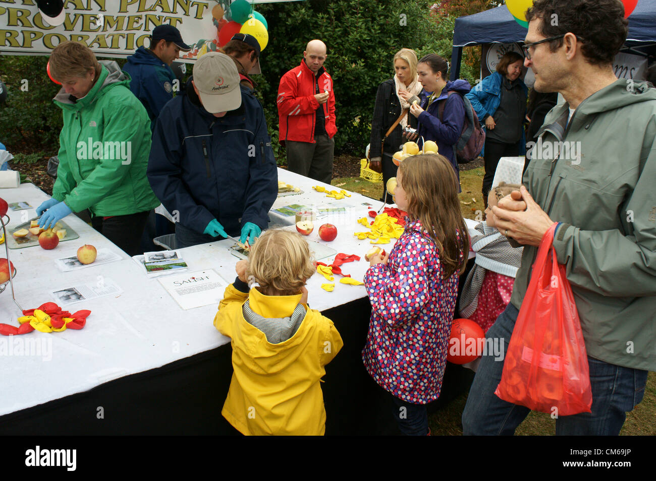 People at an apple tasting booth at the UBC Apple Festival in the ...