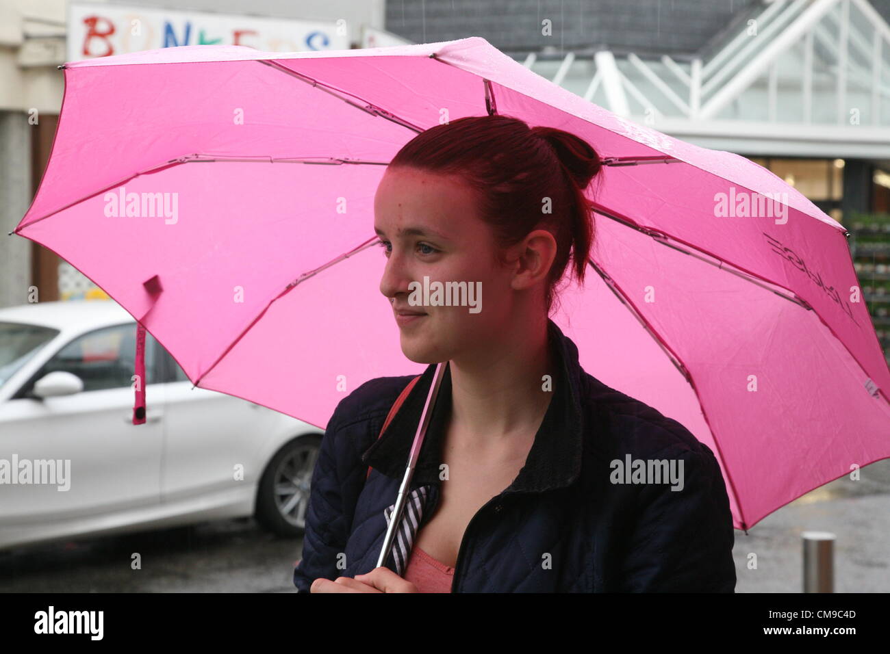 young lady under a umbrella to shelter from the rain Stock Photo - Alamy