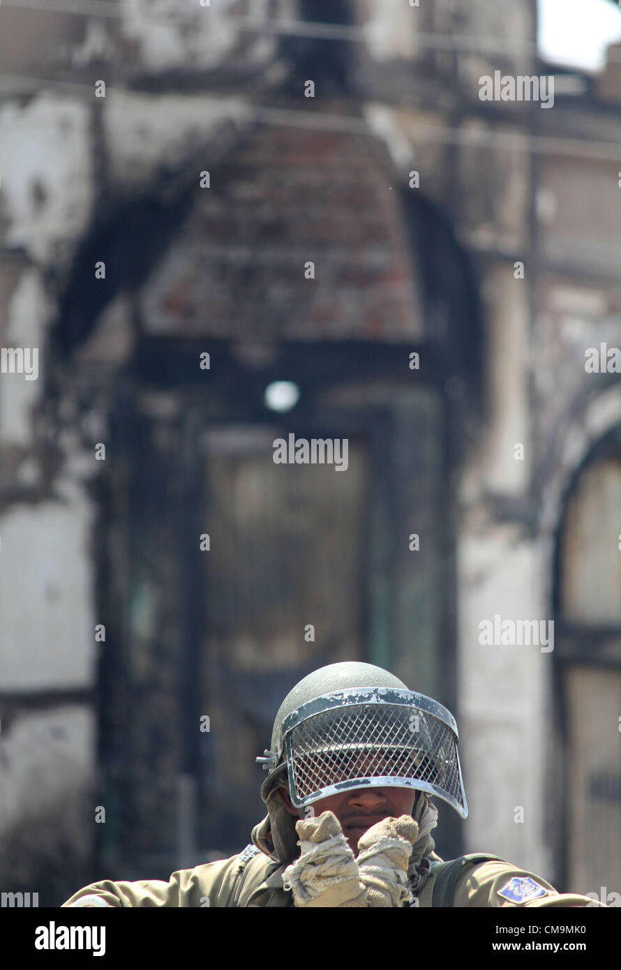 An Indian paramilitary soldier stands guard during an undeclared curfew ...