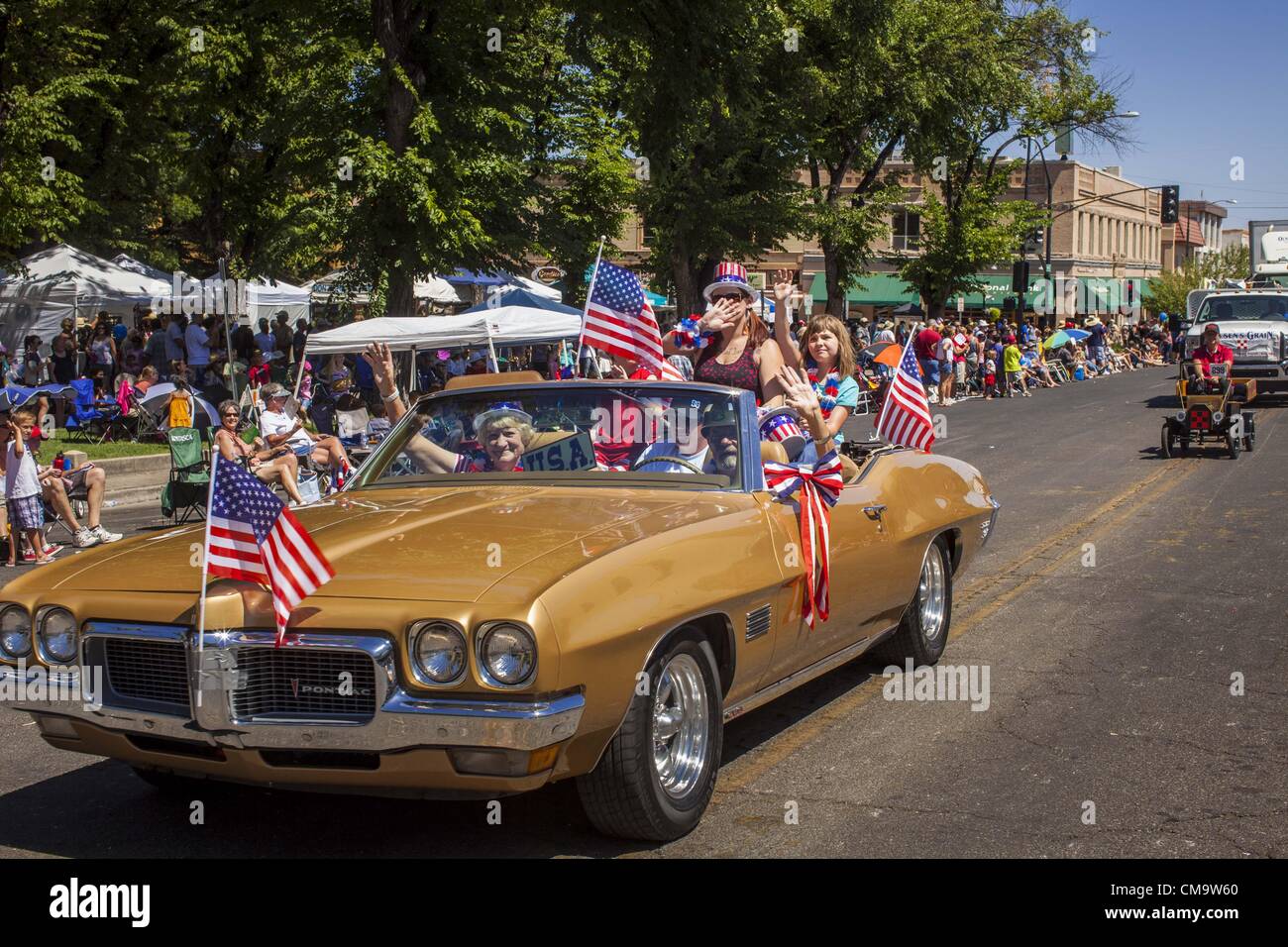 June 30, 2012 - Prescott, Arizona, U.S - People in a flag festooned car ...