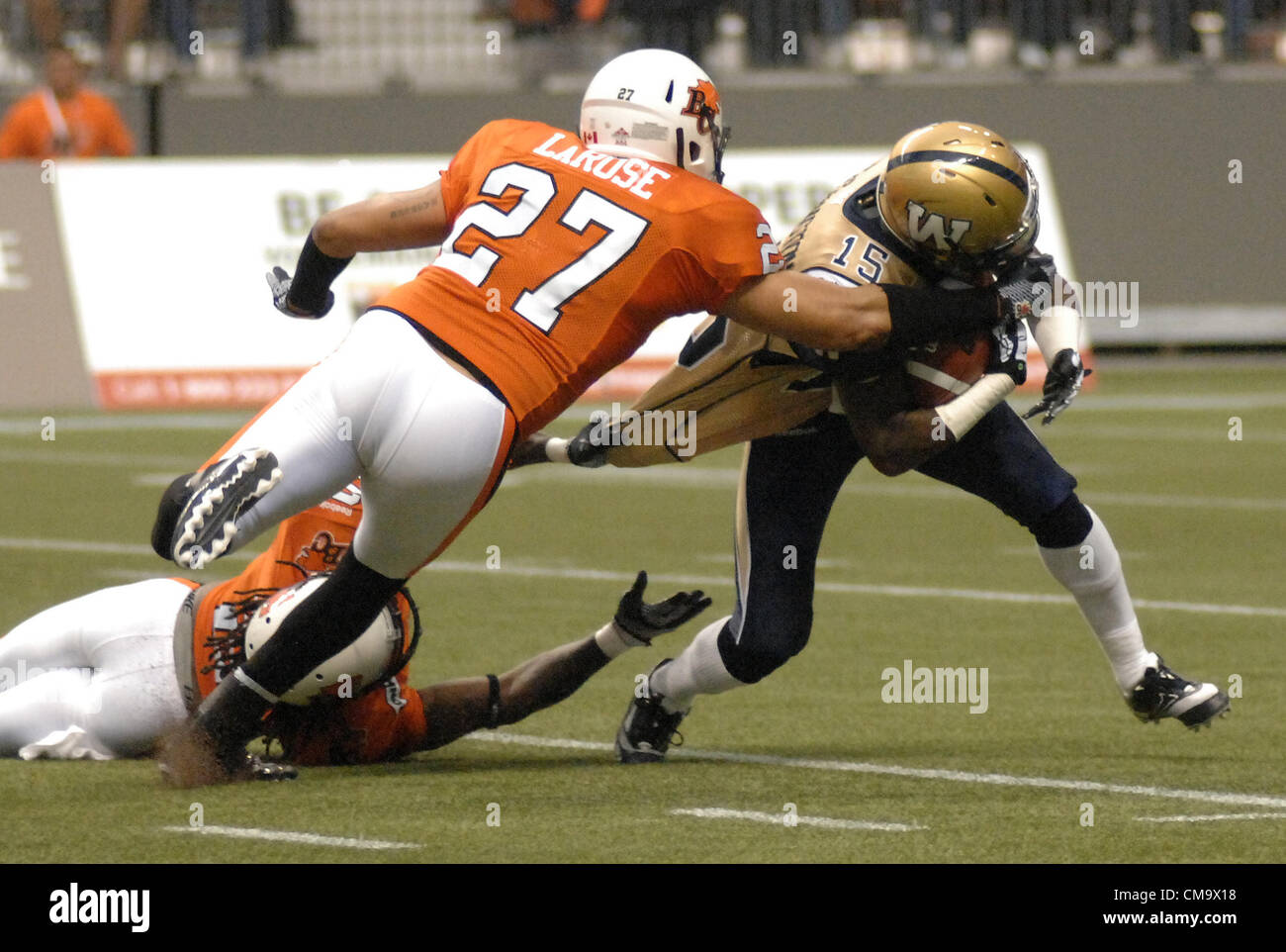 B.C. Lions’ J.R. LaRose #27 vies with Winnipeg Blue Bombers’ Demond ...