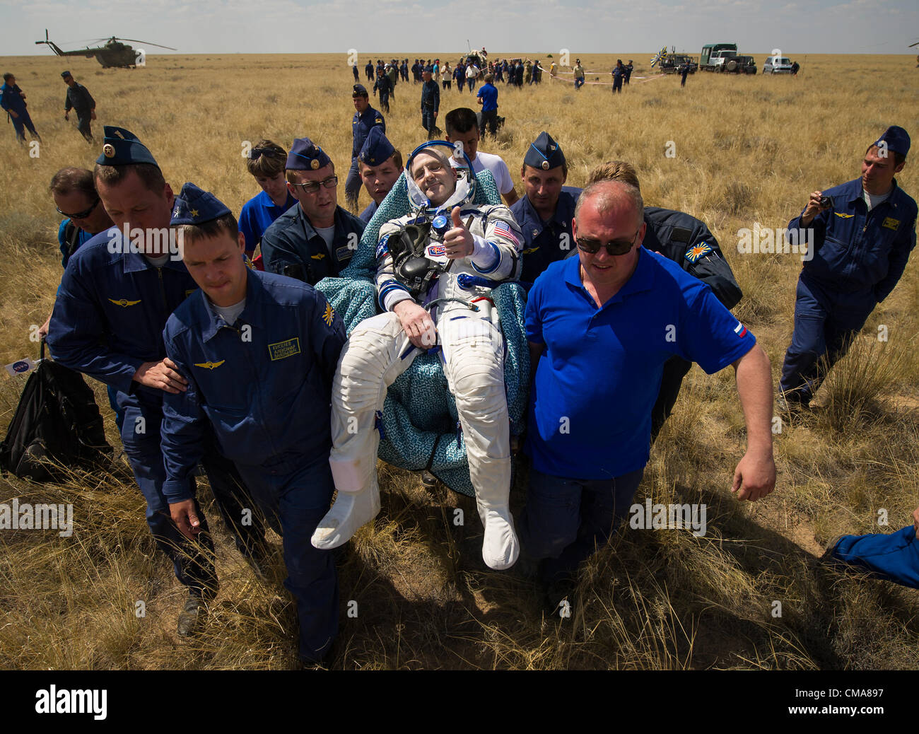 NASA astronaut Don Pettit is carried in a chair to the medical tent ...