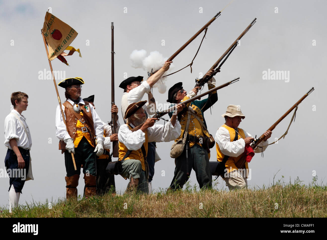 Revolutionary War reenactors fire muskets on a hill during Independence ...