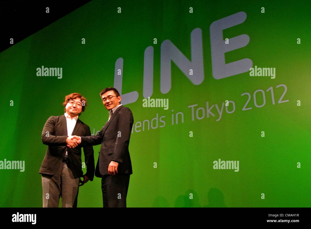 President Akira Morikawa of NHN Japan shakes hands with Makoto Takahashi, associate senior vice ...