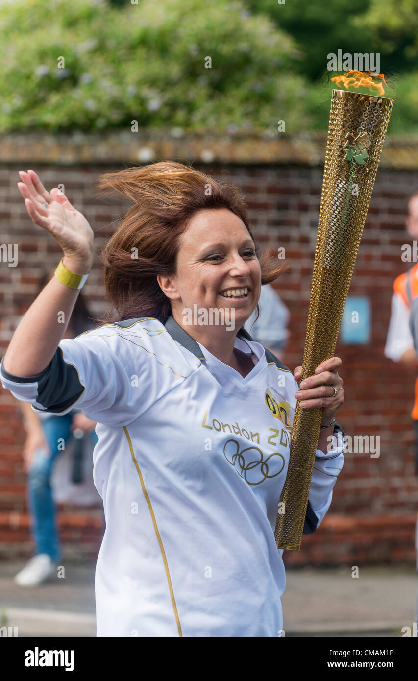 Sarah Corbett runs with the Olympic torch in Aldeburgh, Suffolk, UK ...