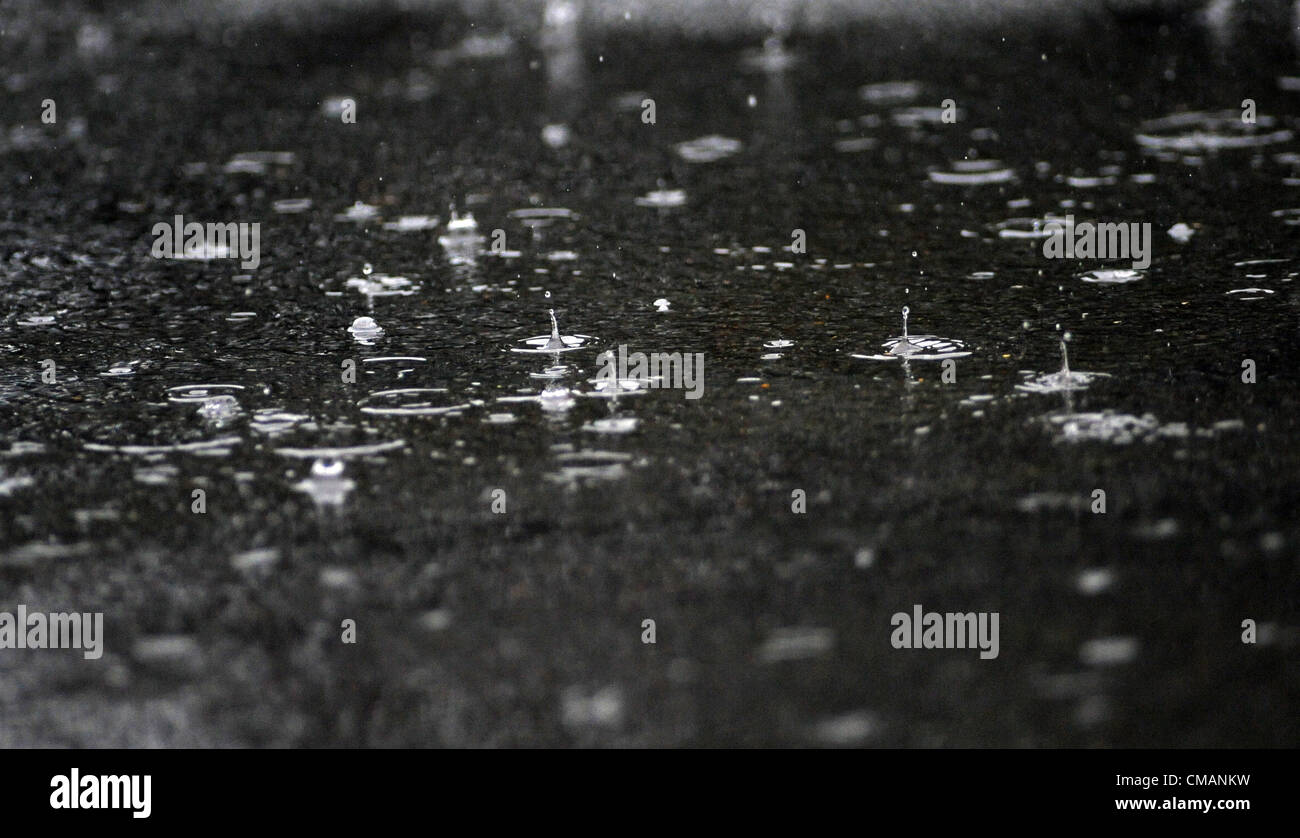 Brighton UK Raindrops exploding on to a Brighton road this morning ...