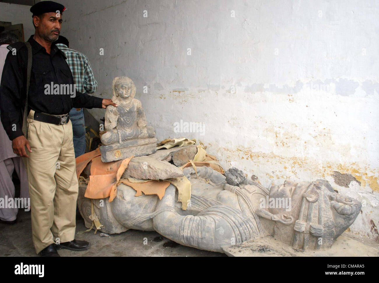 Police officials showing antique statues seized during a raid conducted ...
