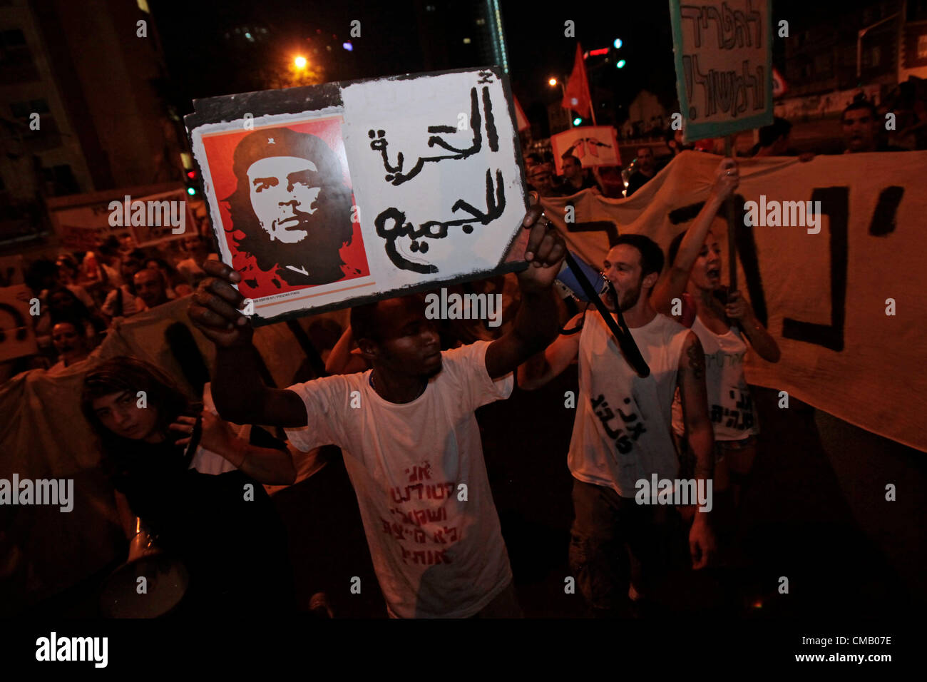An Israeli Arab demonstrator holds a placard with the figure of Marxist ...