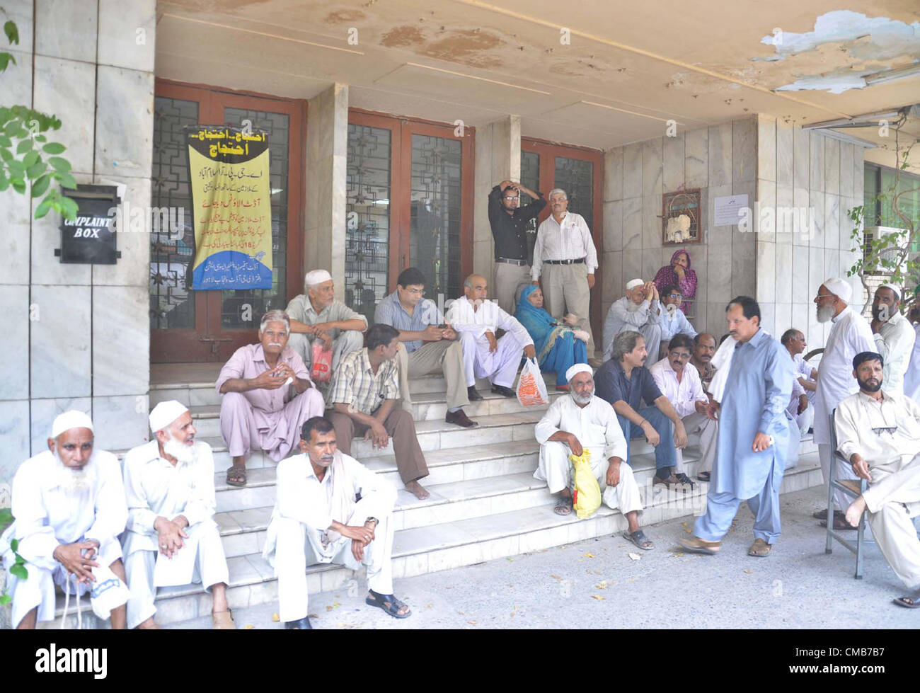 Employees of Accountant General Office gather waiting to open the ...