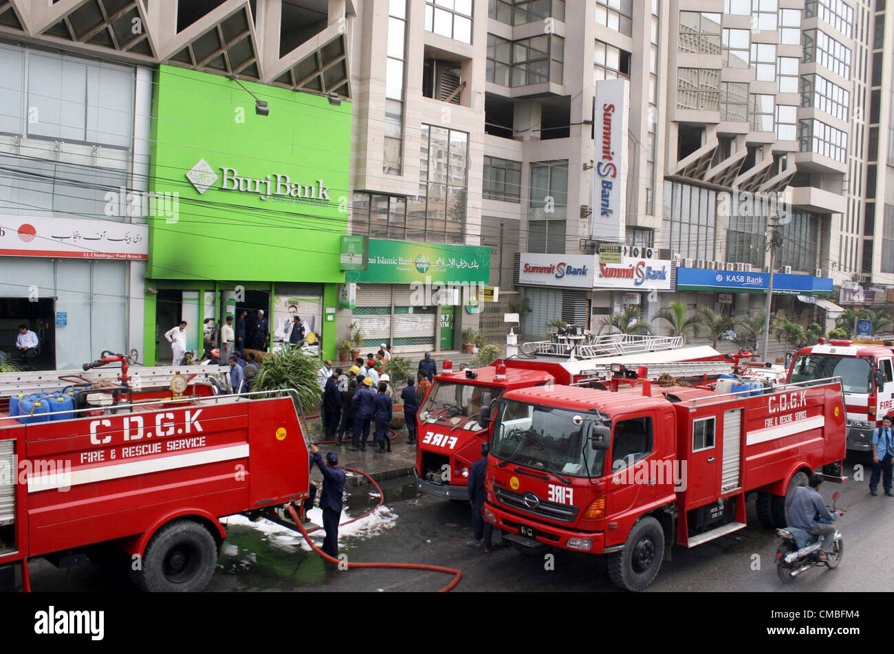 Firefighters extinguish fire on burning building of a local bank after ...