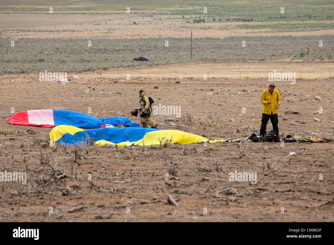 Firemen Smoke Jumpers parachute into wildfire forest fire area to start ...