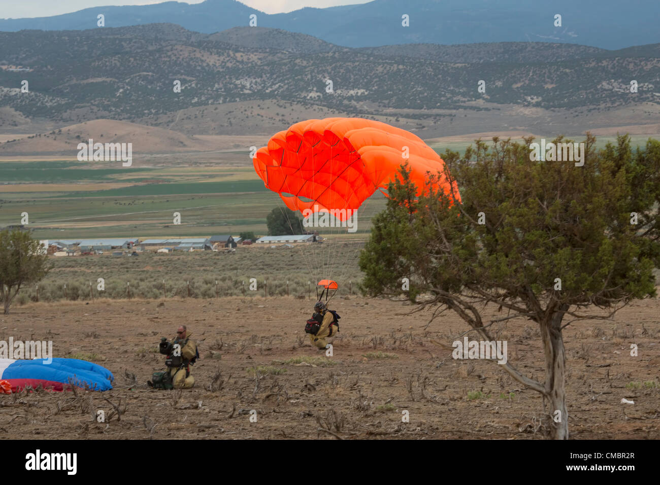 Firemen Smoke Jumpers parachute into wildfire forest fire area to start ...