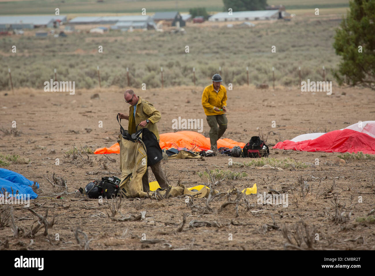Firemen Smoke Jumpers parachute into wildfire forest fire area to start ...