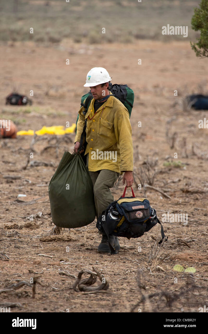 Firemen Smoke Jumpers parachute into wildfire forest fire area to start ...