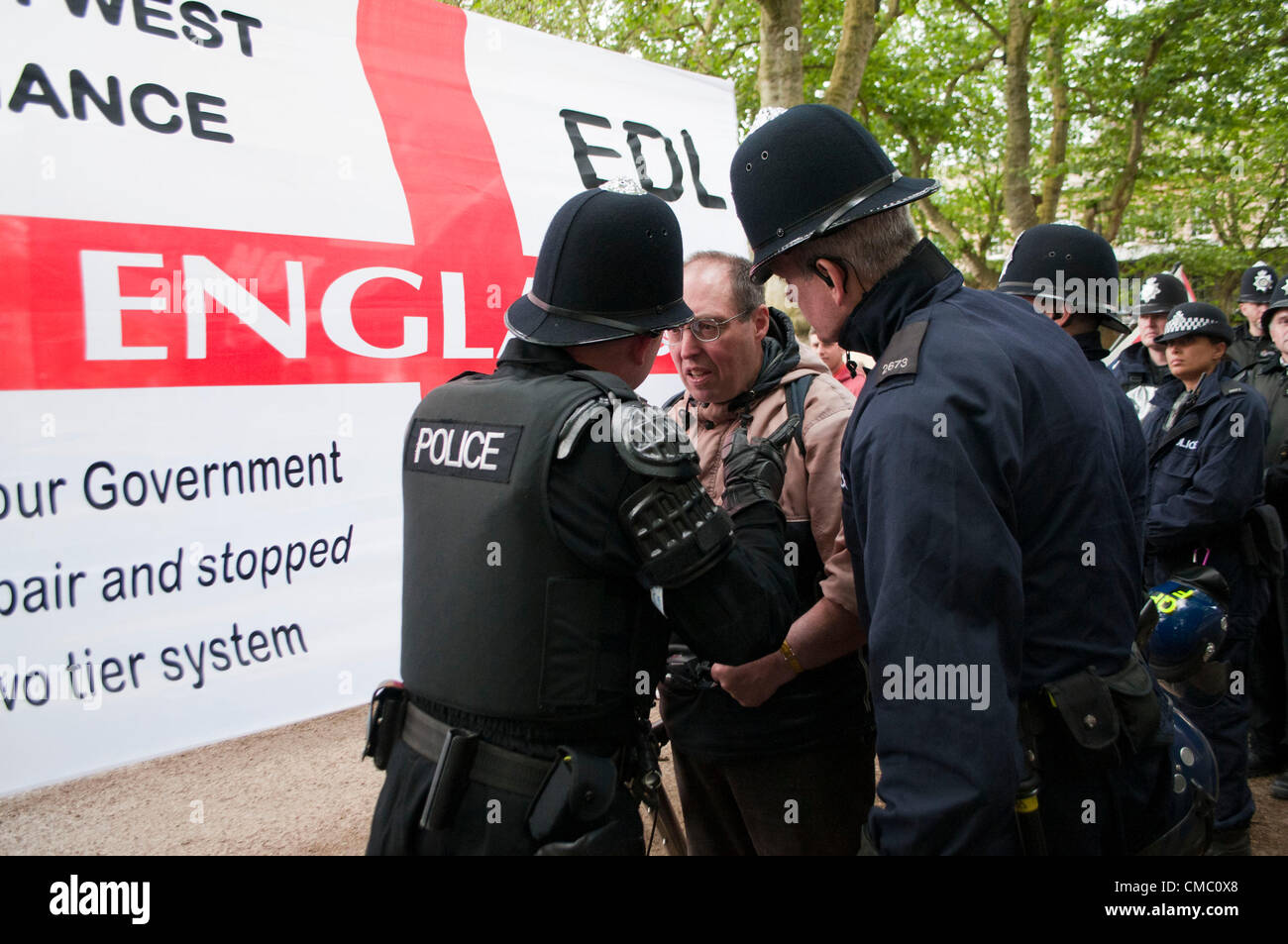 Bristol, UK. 14/07/12. Police try to calm down an angry member, as the ...