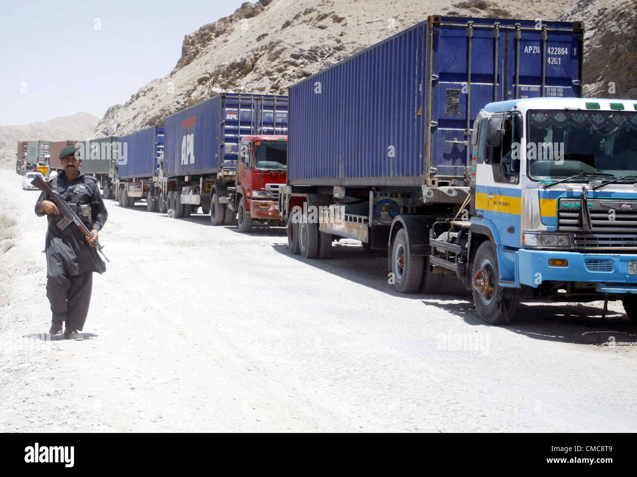 Frontier Constabulary (FC) soldier stands alert while NATO trucks ...