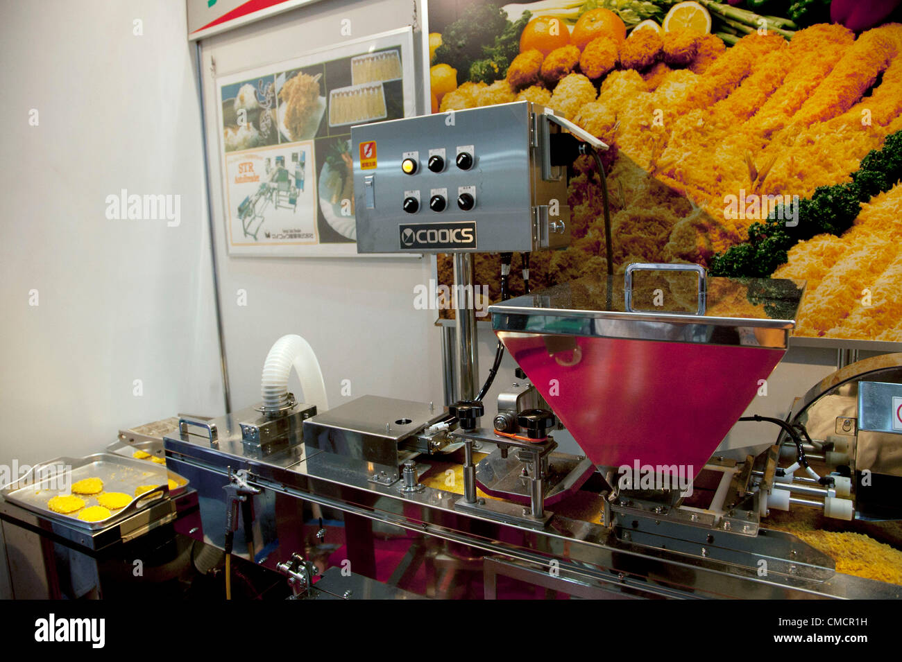July 20 2012, Tokyo, Japan - A machine fryer with samples of food in ...