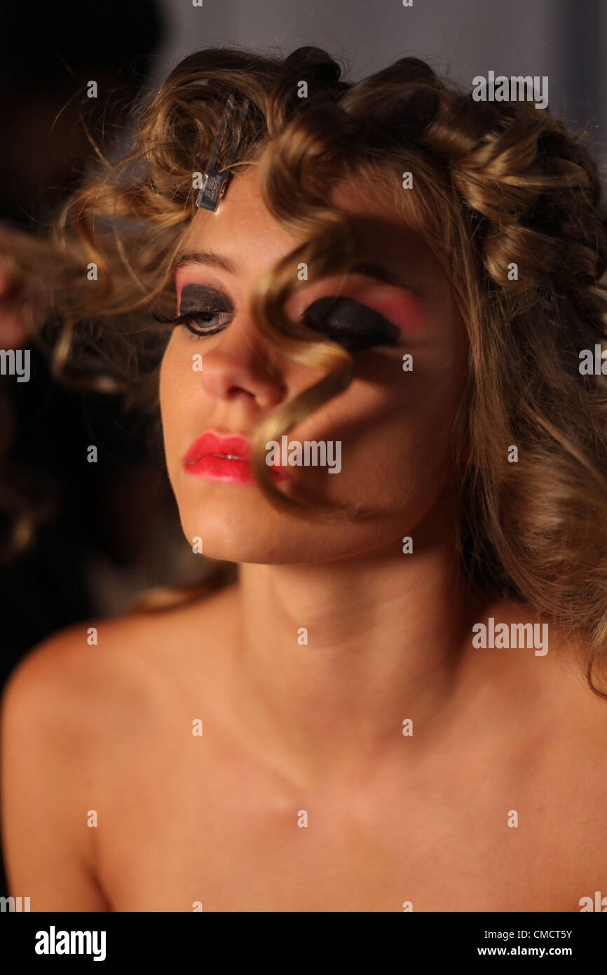 July 20, 2012 - Miami Beach, Florida, U.S. - A model prepares backstage ...