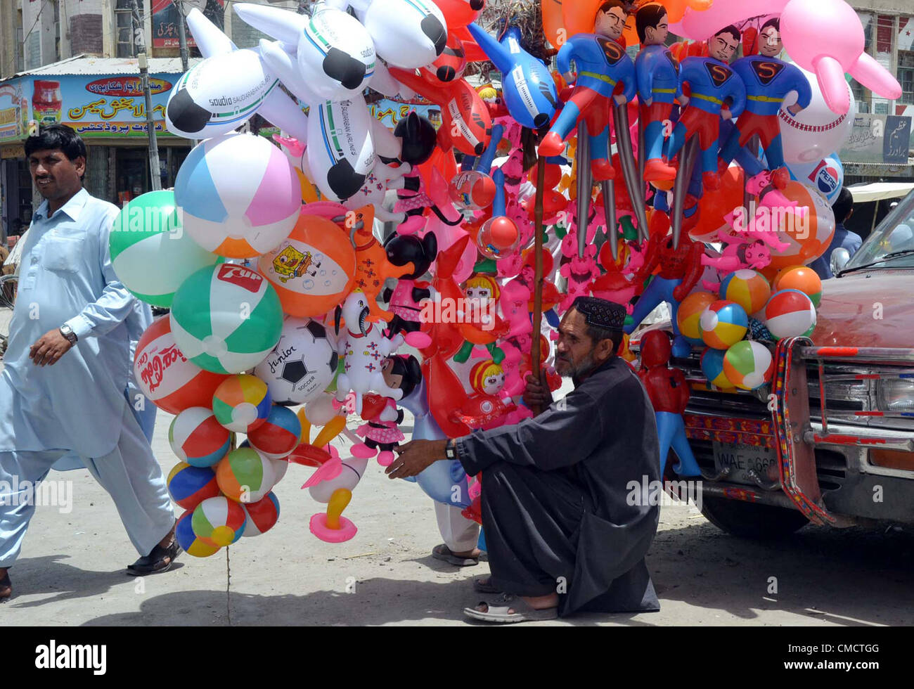 QUETTA, PAKISTAN, JUL 20: A man sells gas balloons to earn his ...