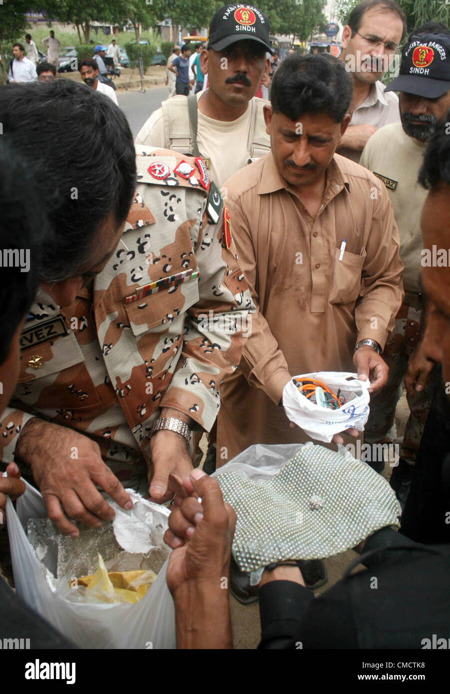 Security officials inspect diffused bomb that was planted on roadside ...