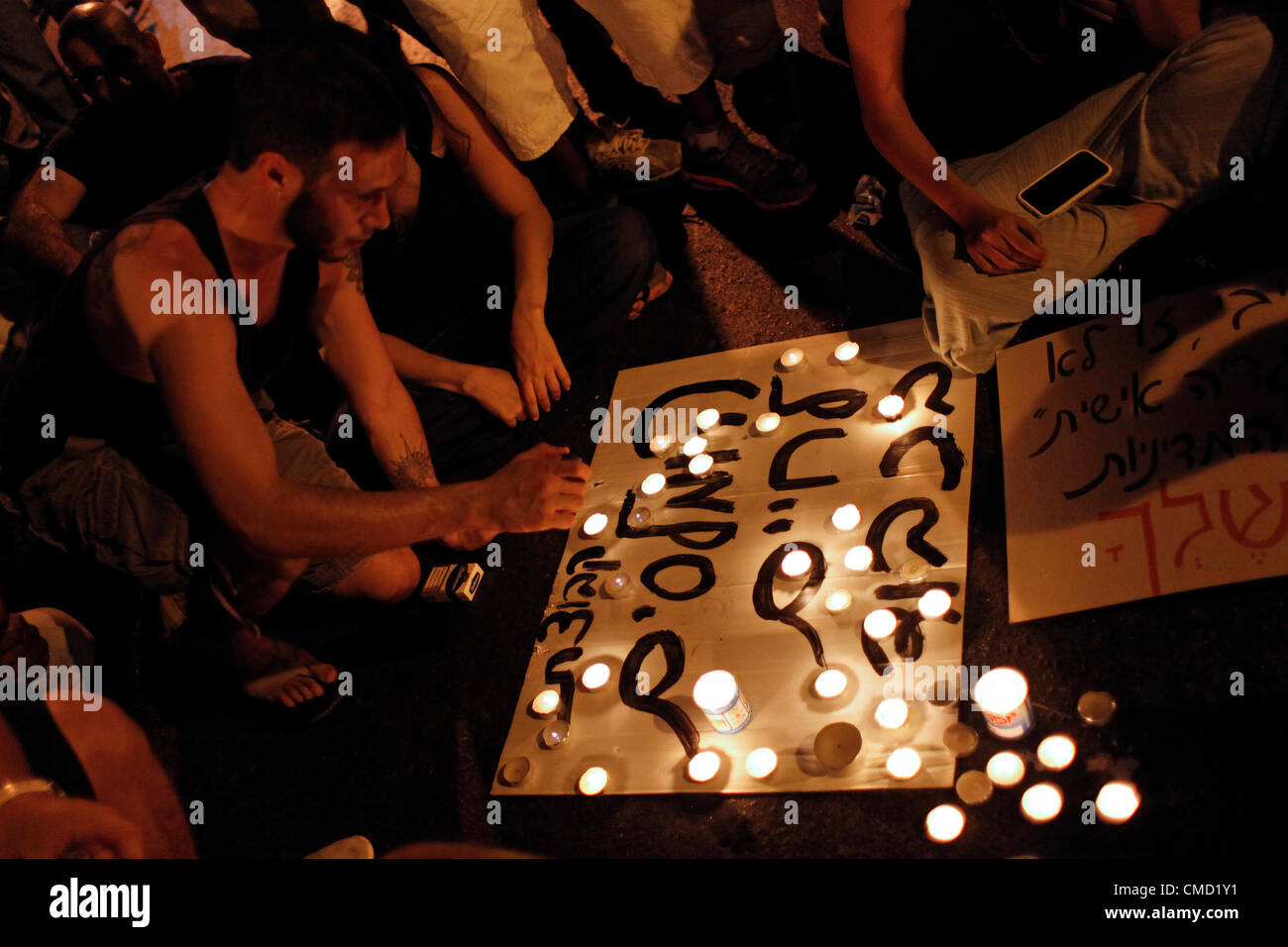 A demonstrator lights memorial candles during a demonstration in memory ...