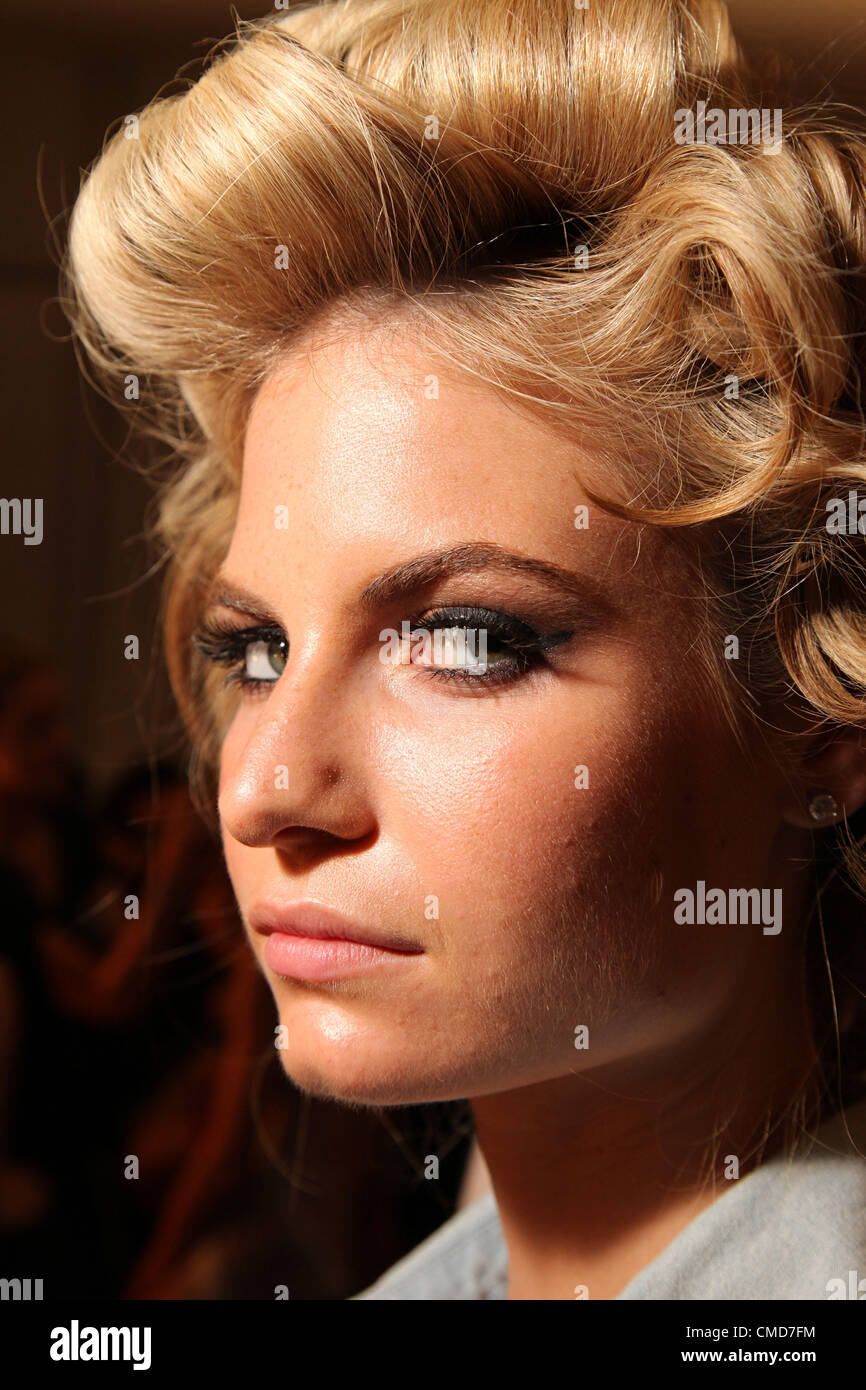 July 22, 2012 - Miami Beach, Florida, U.S. - A model prepares backstage ...