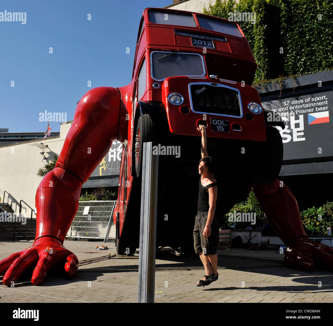 Czech artist David Cerny poses with a British double-decker bus turned ...