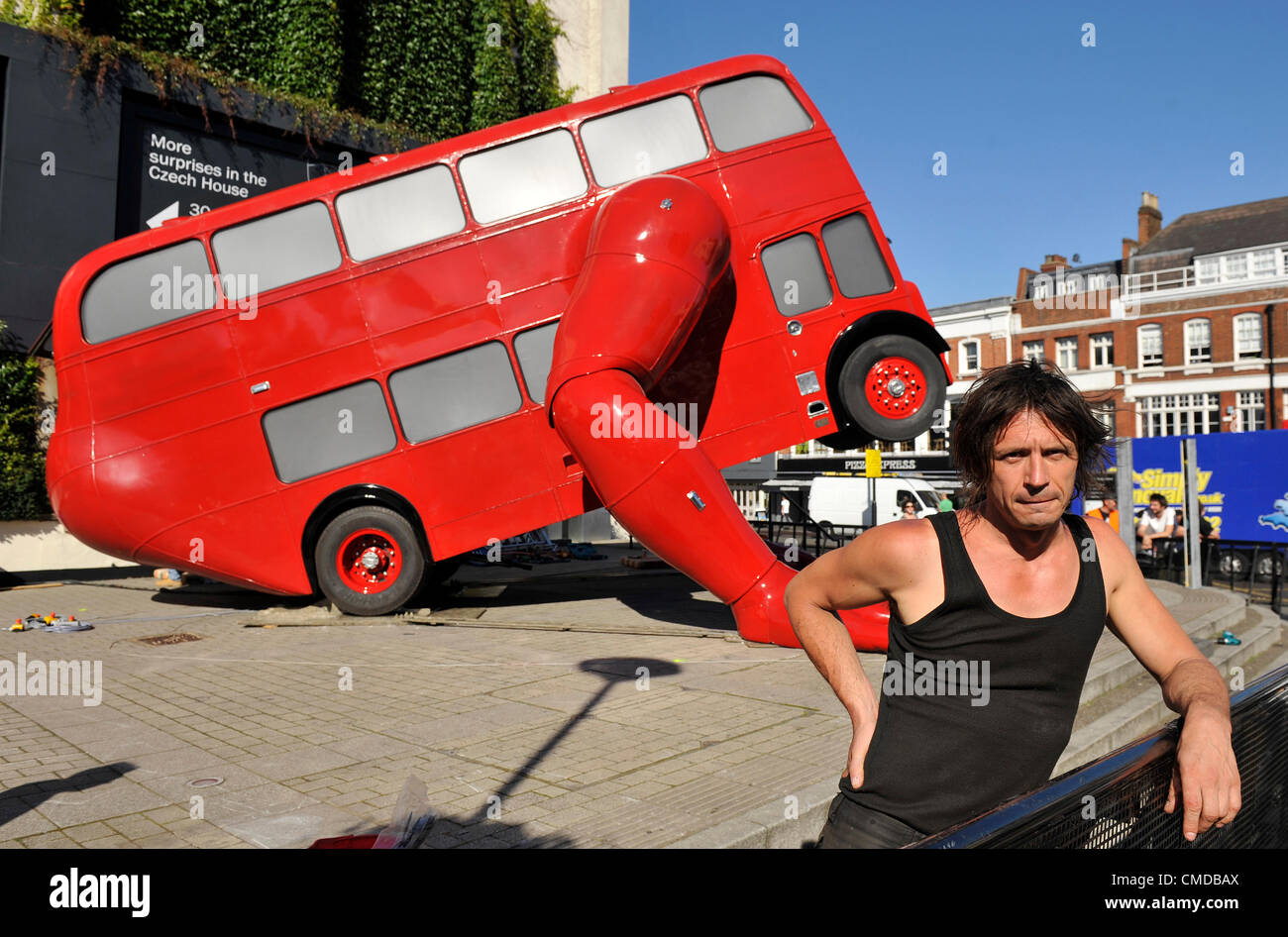 Czech artist David Cerny poses with a British double-decker bus turned ...