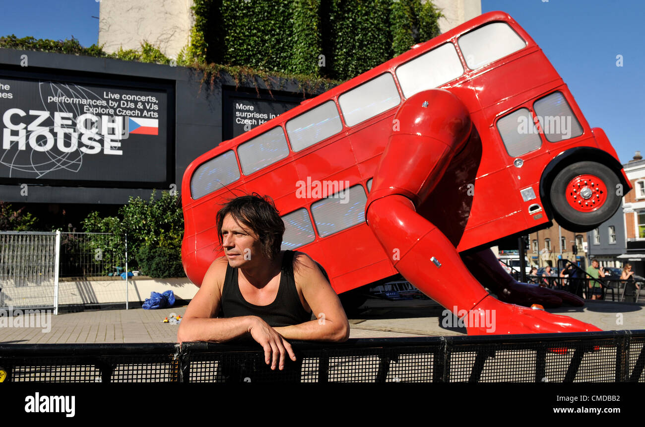 Czech artist David Cerny poses with a British double-decker bus turned ...