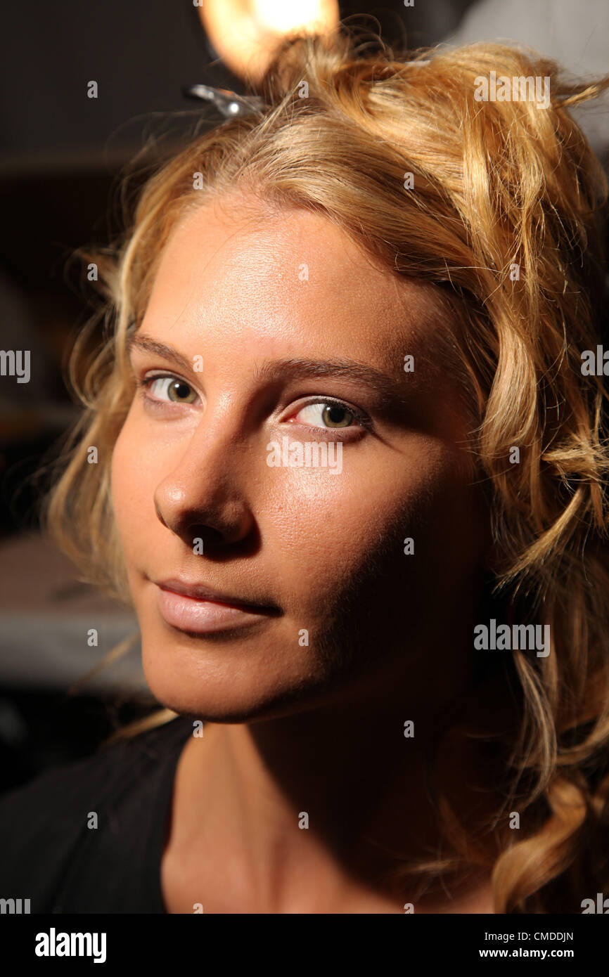 July 23, 2012 - Miami Beach, Florida, U.S. - A model prepares backstage ...