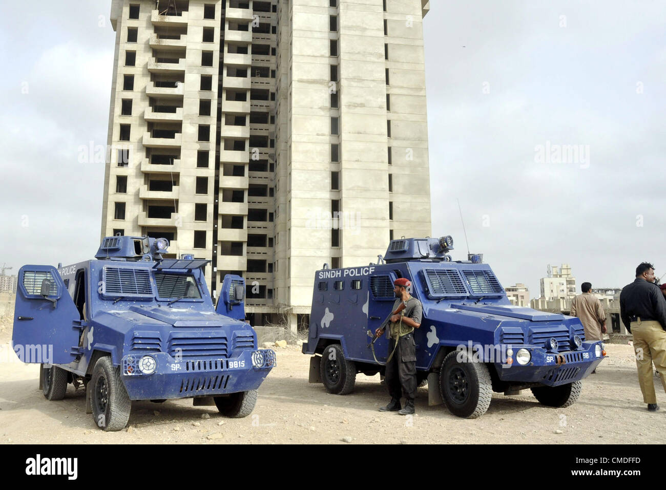 Police officer takes position with police armored (APC) during ...