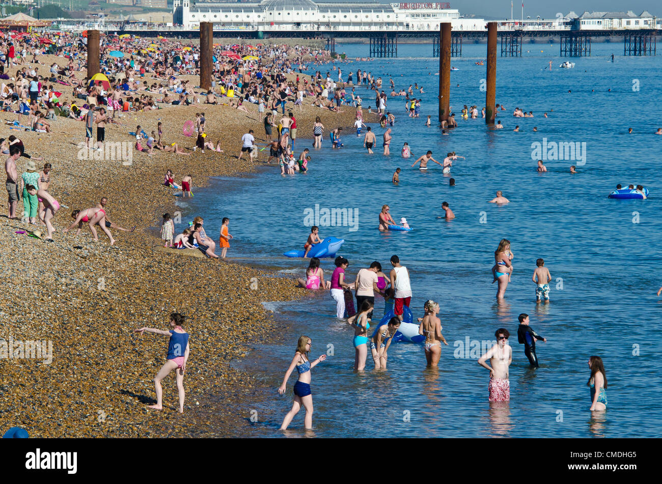 Enjoying the summer sun on Brighton Beach Stock Photo - Alamy