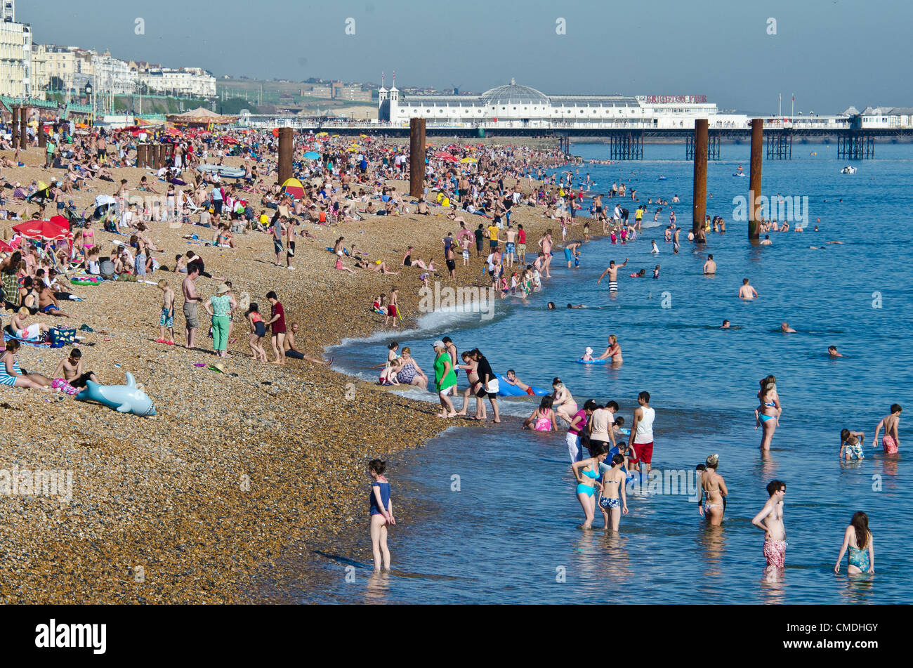 Enjoying the summer sun on Brighton Beach Stock Photo - Alamy