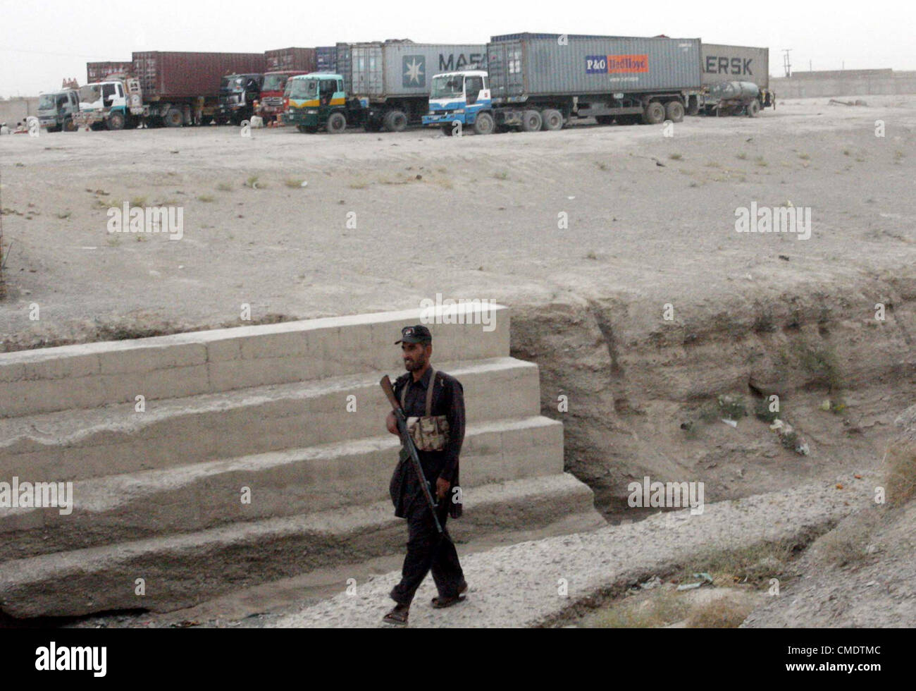 Frontier Constabulary (FC) soldier stands alert while NATO trucks ...