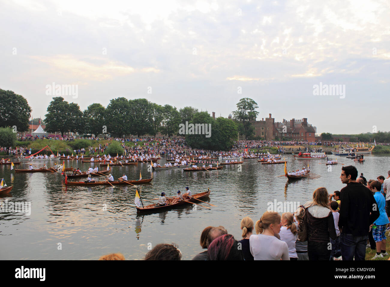 27 July 2012. Hampton Court, England, UK. A flotilla of rowing boats ...