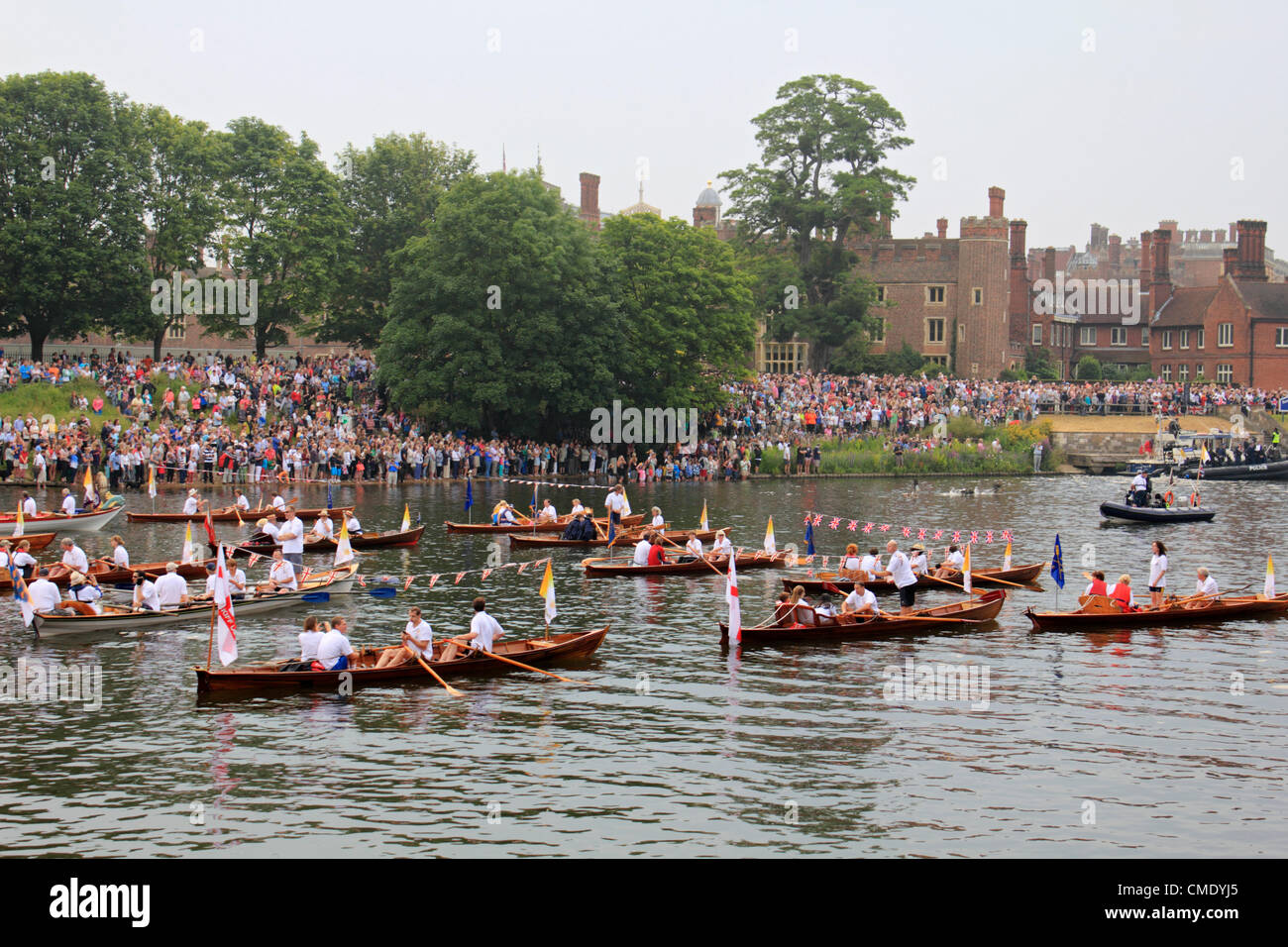 27 July 2012. Hampton Court, England, UK. A flotilla of rowing boats ...