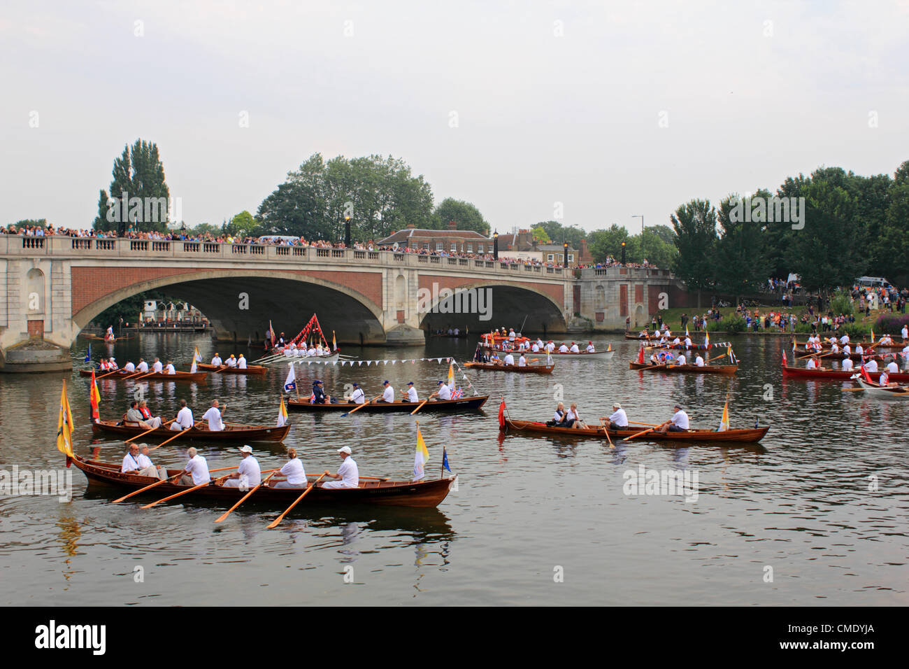 27 July 2012. Hampton Court, England, UK. A flotilla of rowing boats ...