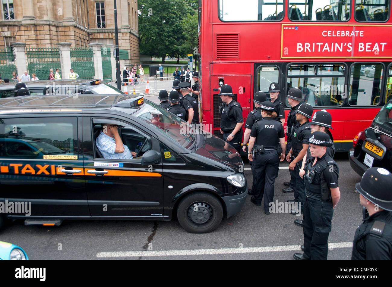 London, UK. 27/07/12. Police form a line to filter traffic out of the ...