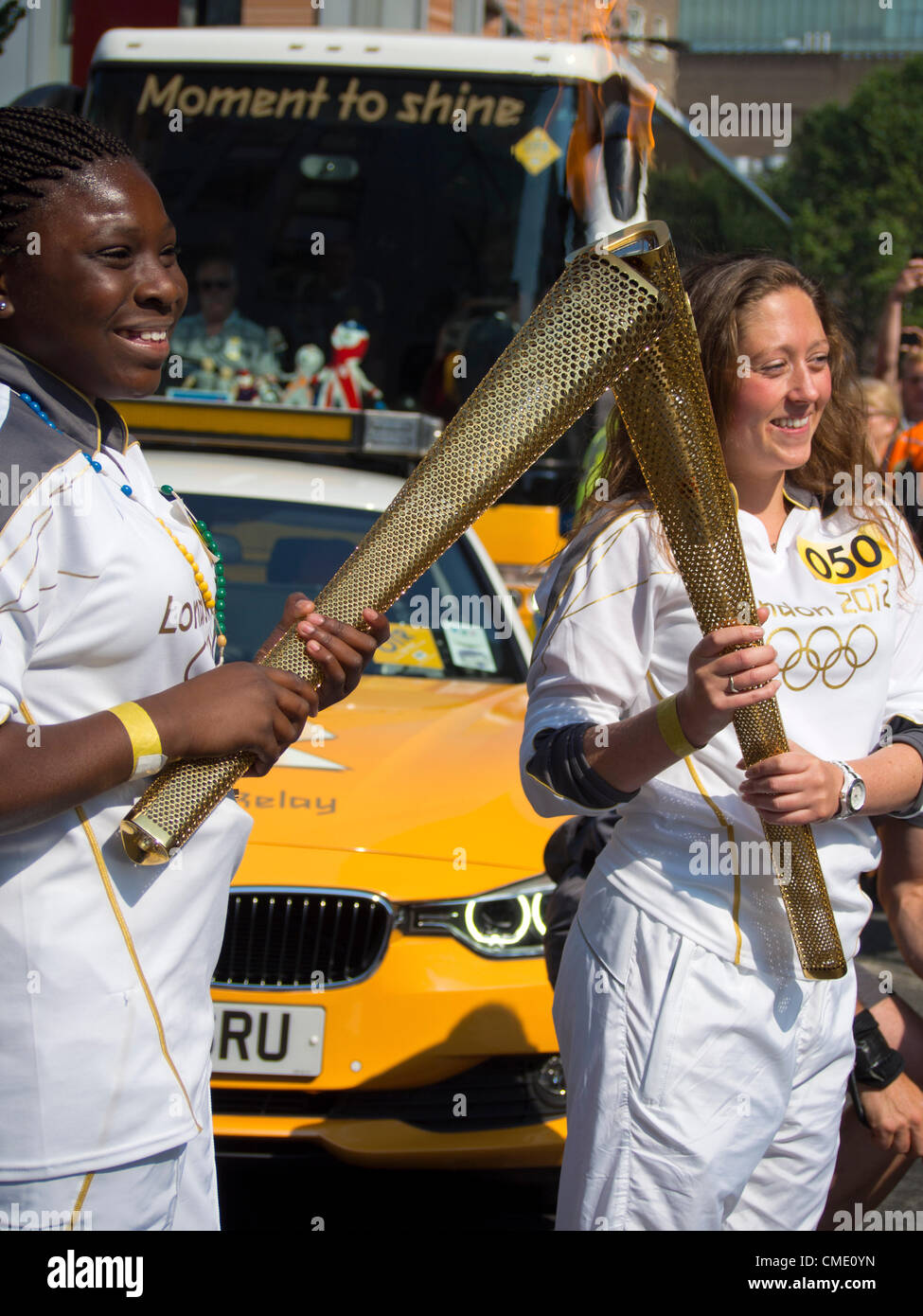 London, UK. 26 July, 2012. Passing the Olympic torch in Southwark 2 ...