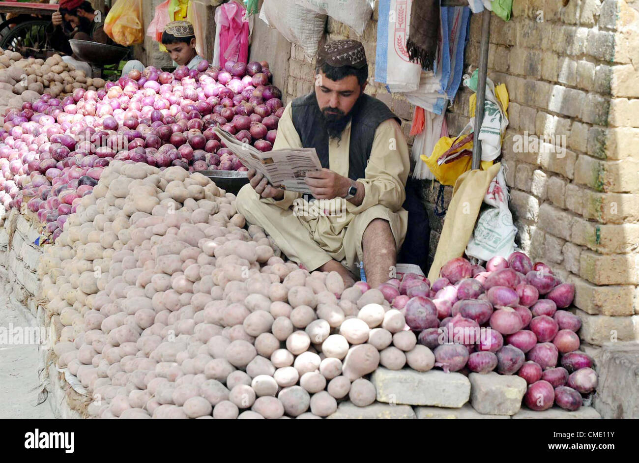 QUETTA, PAKISTAN, JUL 27: Vendors sell potato and onion at roadside ...